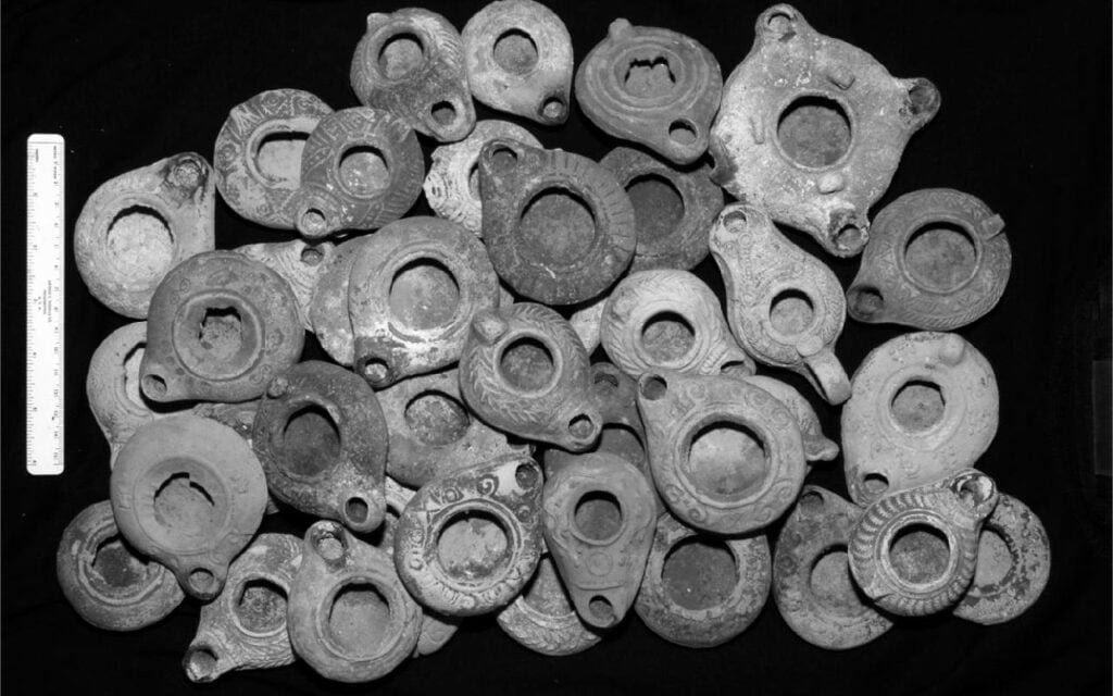 2,000-year-old oil lamps, spearheads and skulls reveal evidence of ...